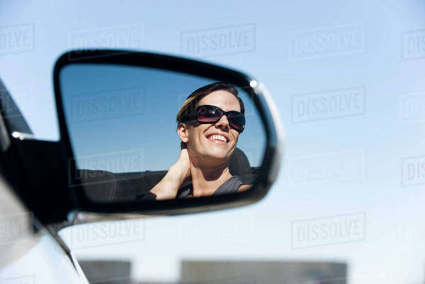 Woman passenger in car, reflection in side-view mirror - Royalty-free ...