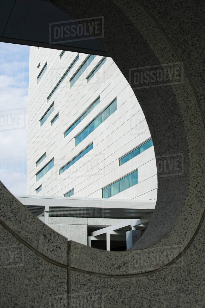 View of skyscraper through window in wall - Stock Photo - Dissolve