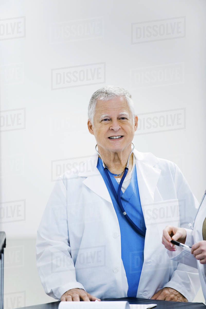 Doctor smiling, portrait - Royalty-free Stock Photo | Dissolve