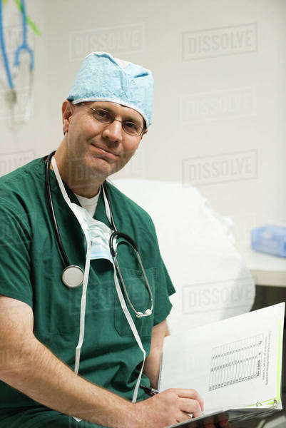 Surgeon reviewing patient's medical chart, portrait - Royalty-free ...