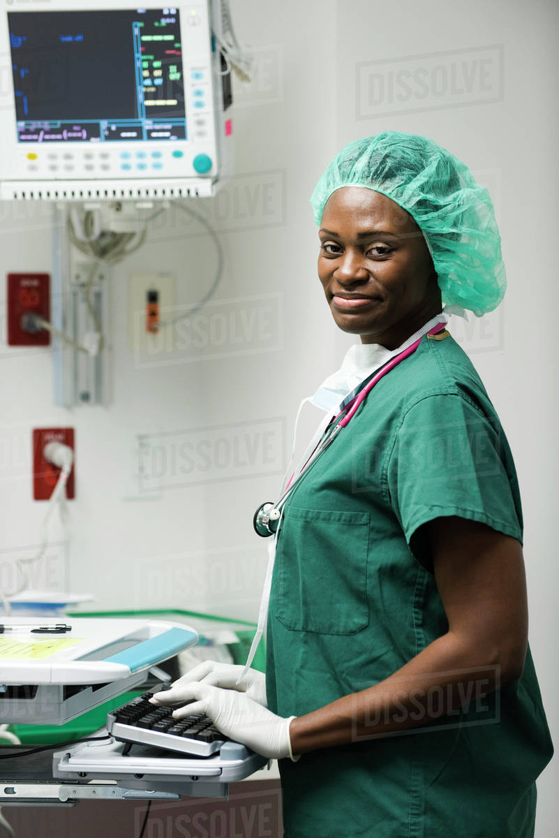 Nurse using computer in hospital room - Royalty-free Stock Photo | Dissolve