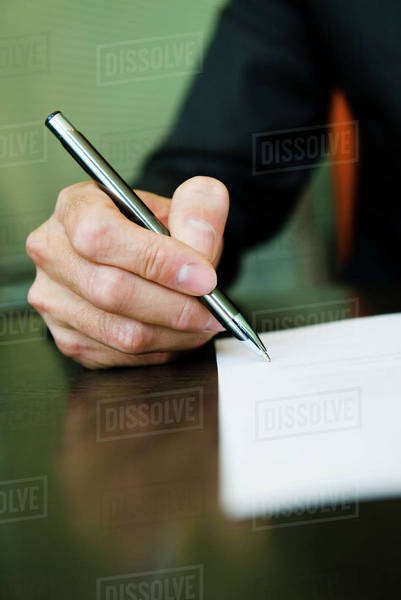 Person signing paperwork, cropped - Royalty-free Stock Photo | Dissolve