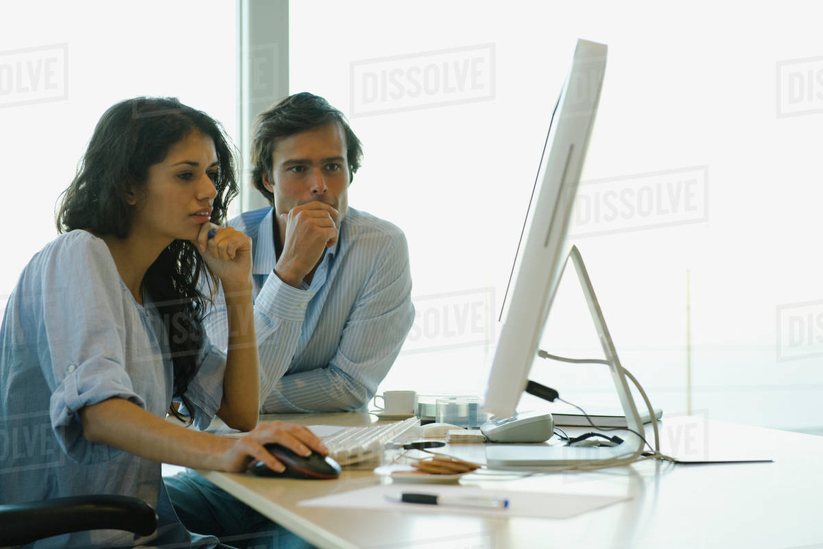 Couple working on computer at home - Stock Photo - Dissolve