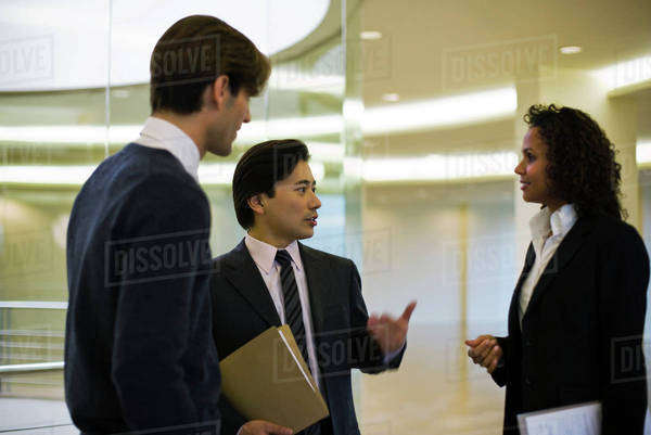 Executives talking in corridor - Royalty-free Stock Photo | Dissolve
