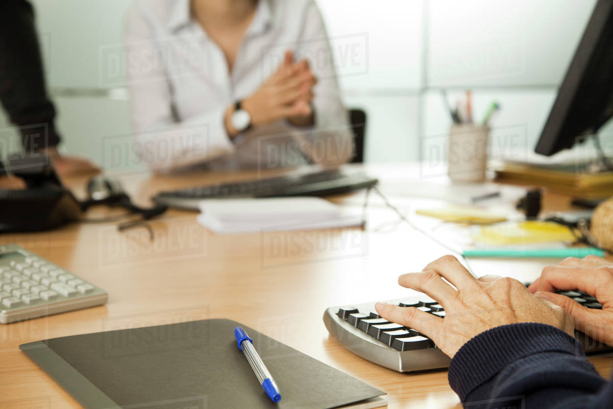 Working in office, cropped - Royalty-free Stock Photo | Dissolve