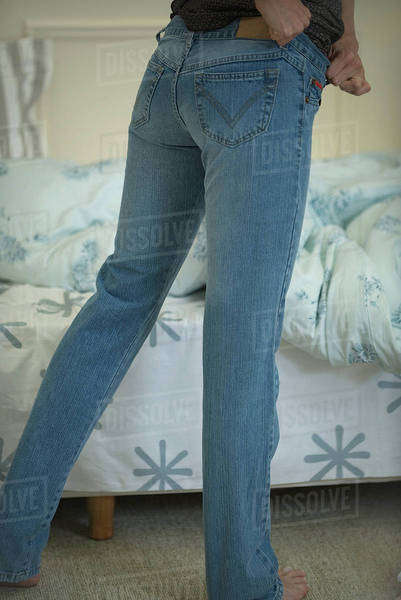 Woman putting on snug-fitting jeans, cropped view - Royalty-free Stock ...