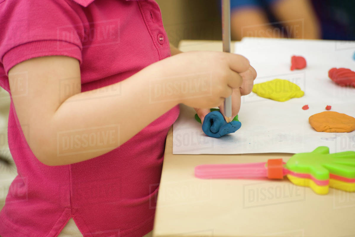 Child molding clay with pencil, cropped - Royalty-free Stock Photo ...