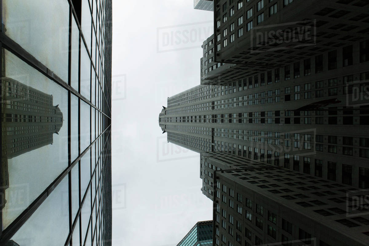 Reflection of skyscraper on glass facade of building on opposite side ...