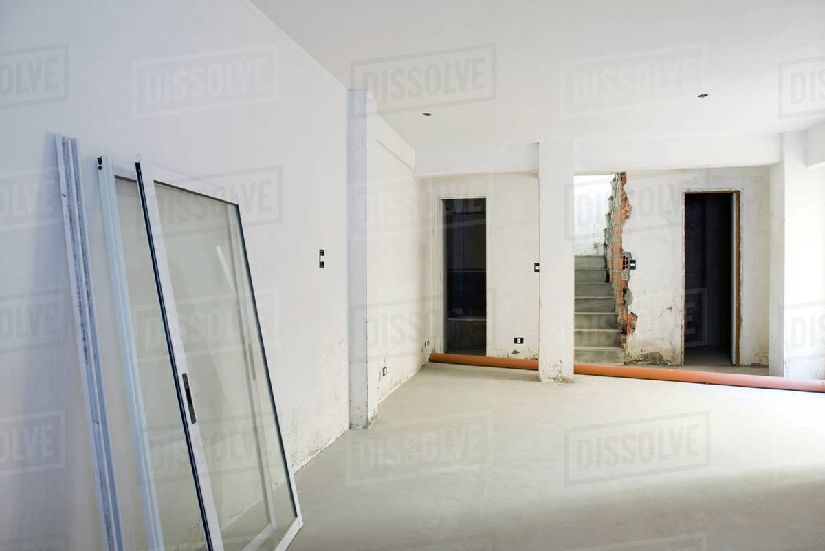 Interior of apartment under renovation, windows leaning against wall ...