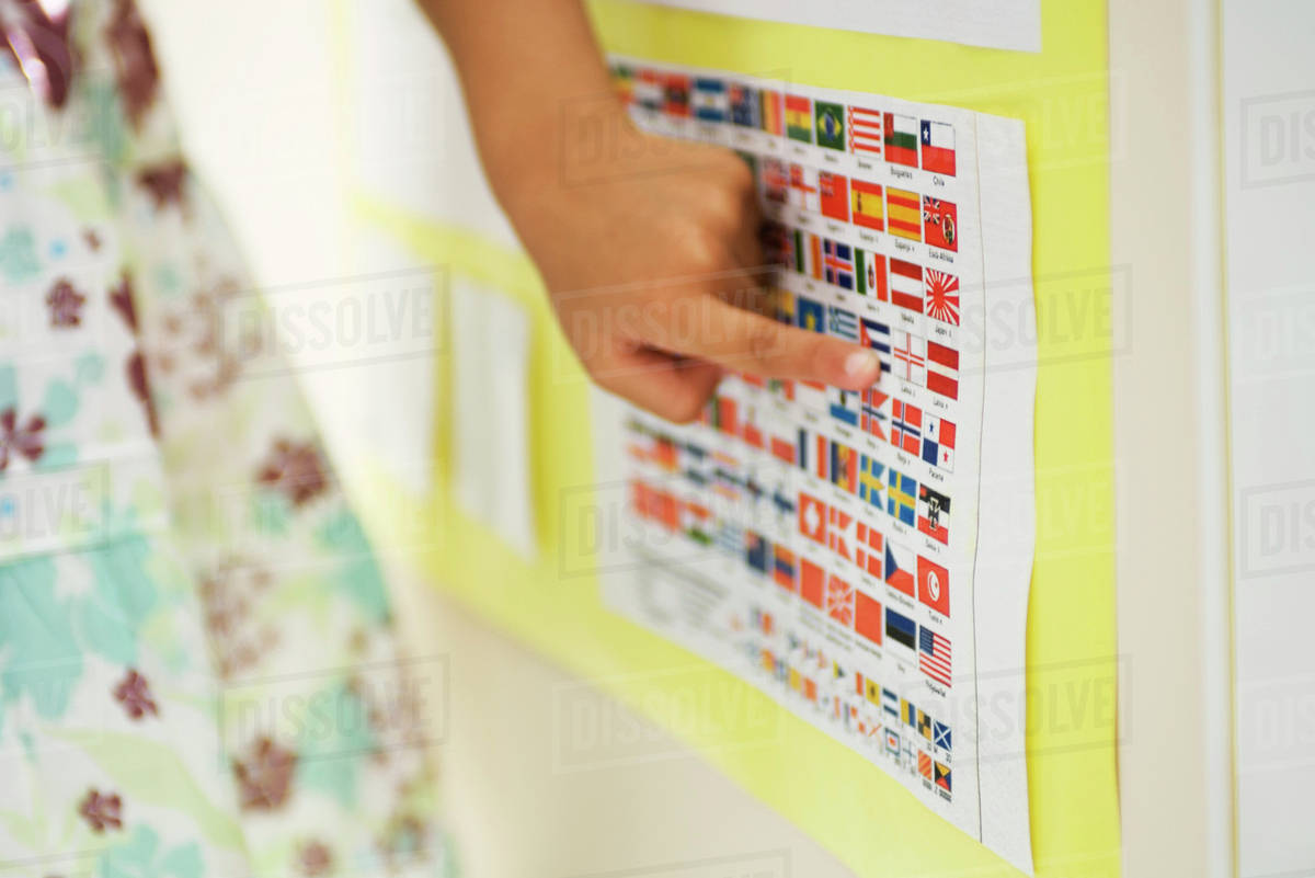 Elementary student pointing to flag on chart, cropped - Royalty-free ...