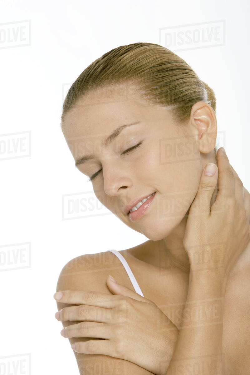 Young woman touching neck and shoulder, smiling, eyes closed - Royalty ...