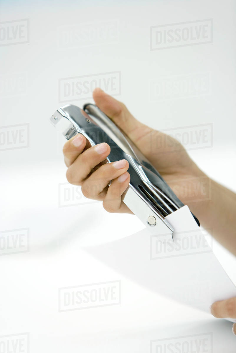 Person using stapler, cropped view of hands - Royalty-free Stock Photo ...