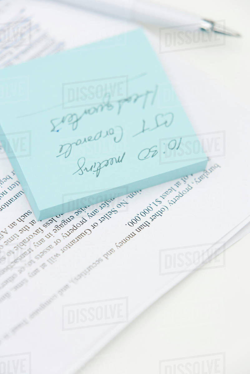 Message written on adhesive note and document, close-up - Royalty-free ...