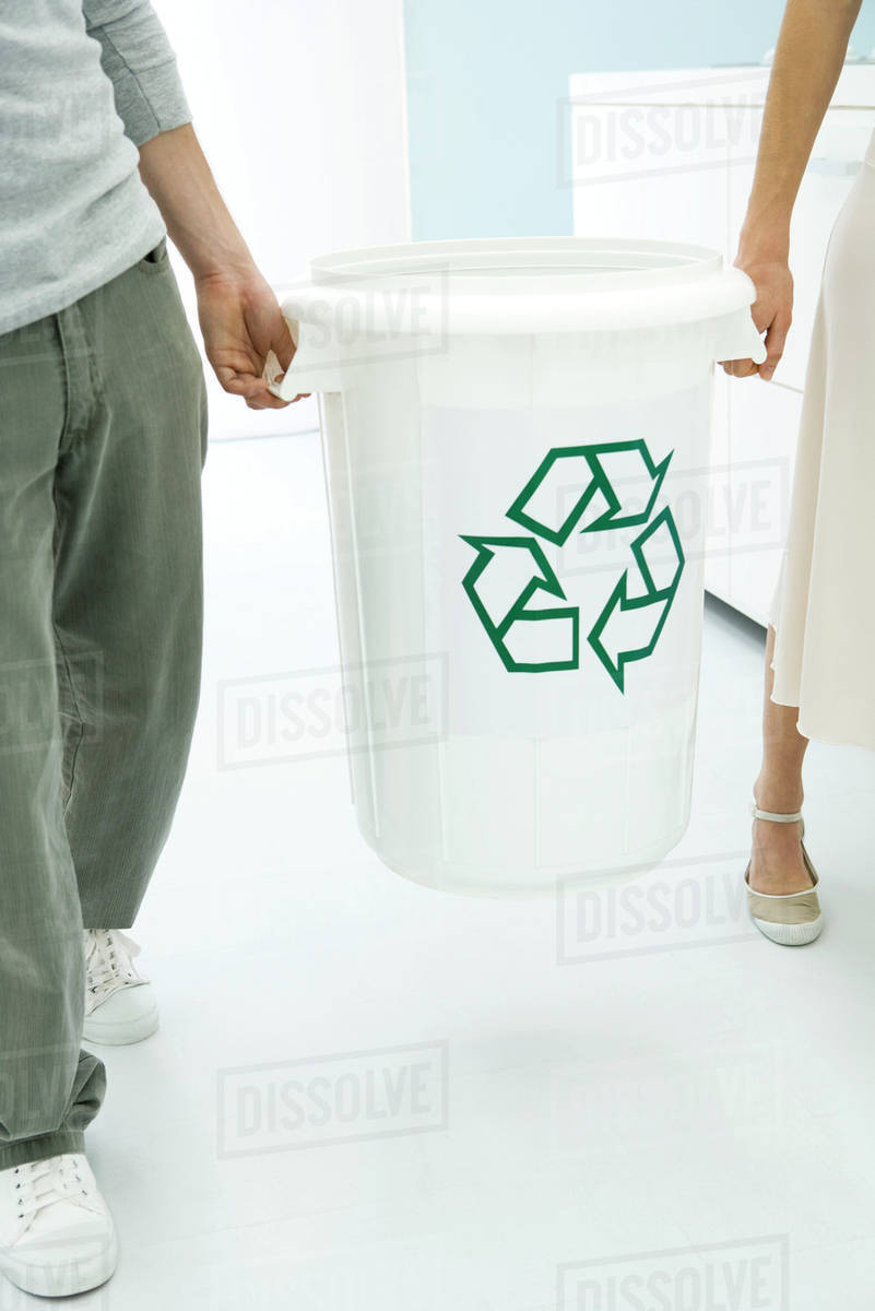 Two people carrying recycling bin together, cropped view - Royalty-free ...