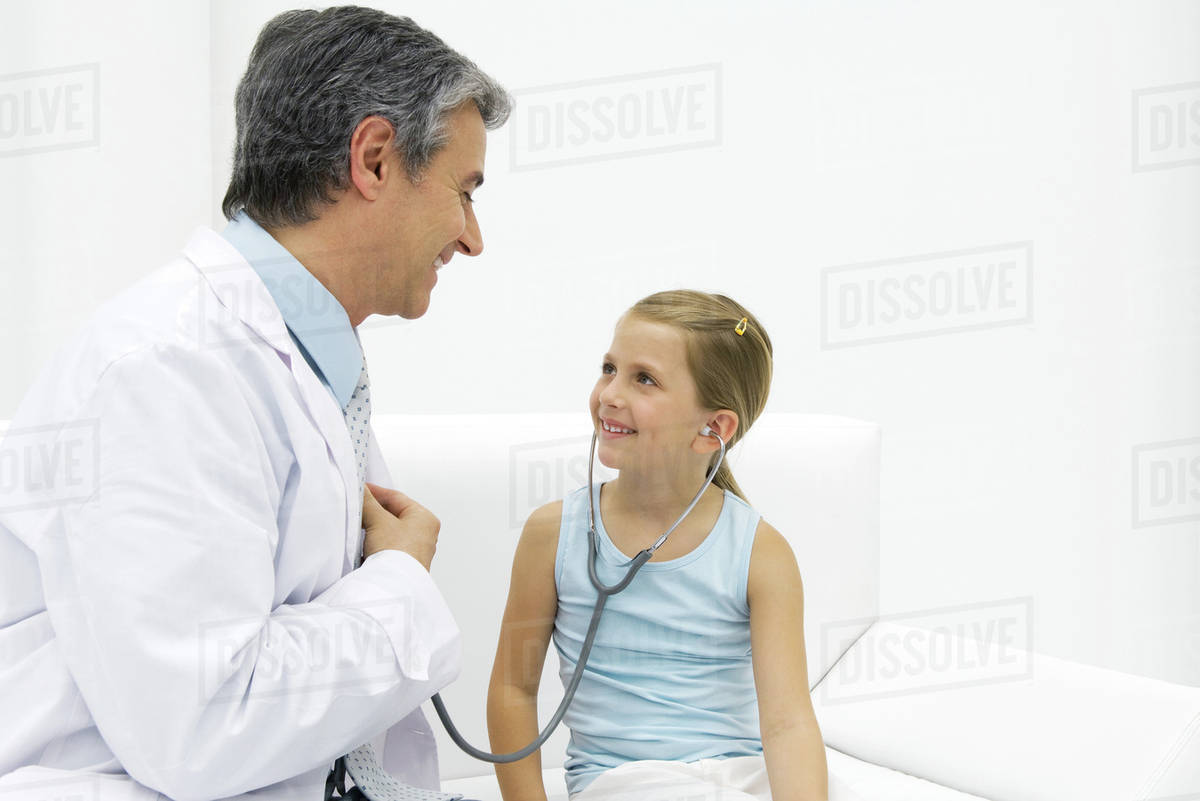 Girl listening to doctor's heart with stethoscope, smiling - Royalty ...