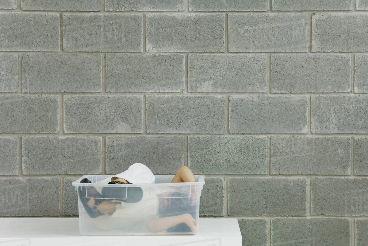 Little boy scrunched up in plastic storage container - Royalty-free ...