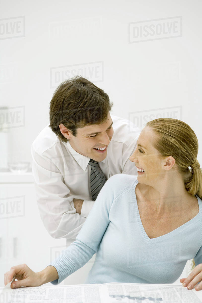 Couple smiling at each other, woman looking back over her shoulder ...