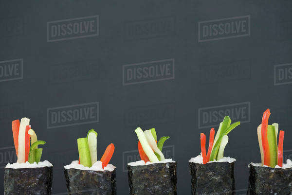 Row of colorful maki sushi, side view - Stock Photo - Dissolve