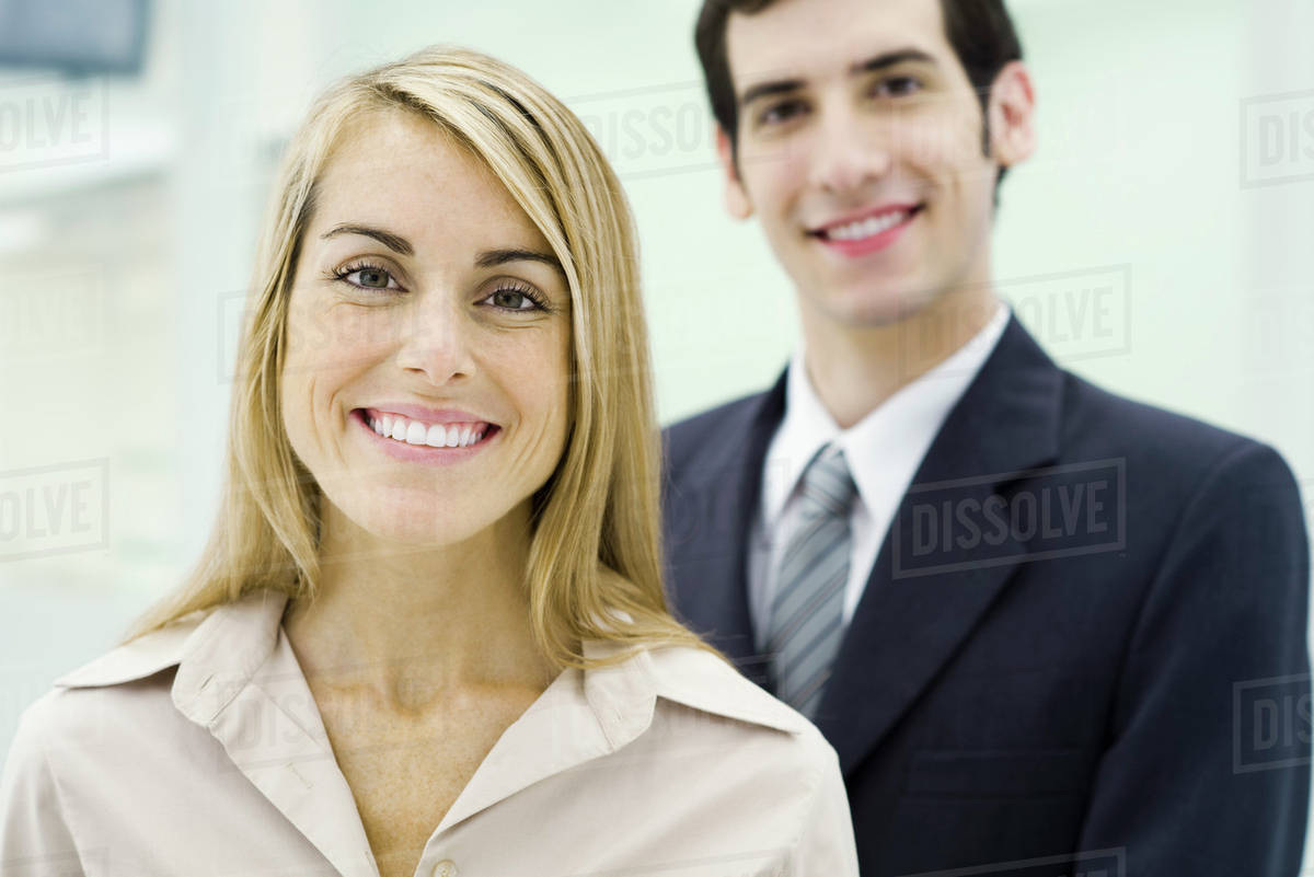 Two professionals smiling at camera, portrait - Royalty-free Stock ...