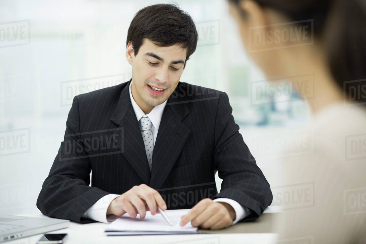 Businessman explaining document to client - Royalty-free Stock Photo ...