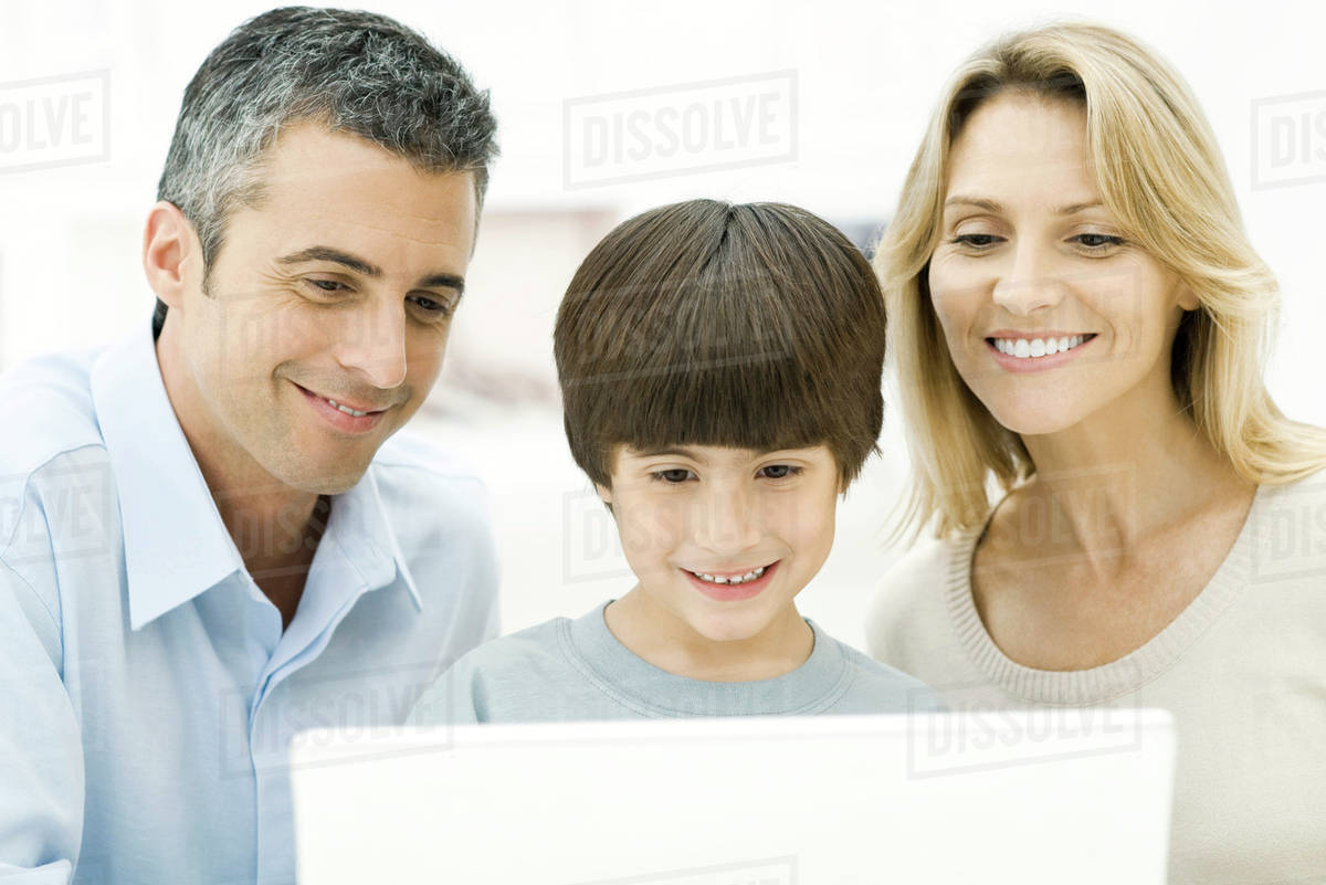 Family using laptop computer together, smiling - Royalty-free Stock ...