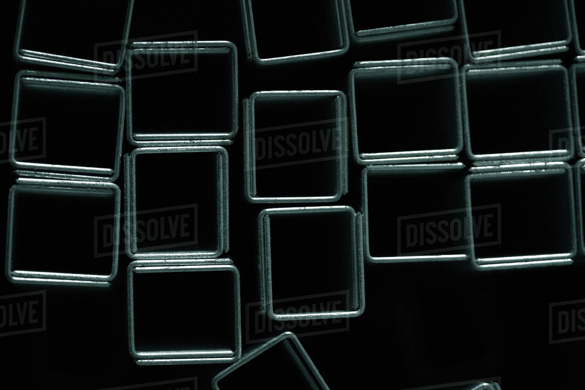 Staples forming squares on black background, close-up - Stock Photo ...
