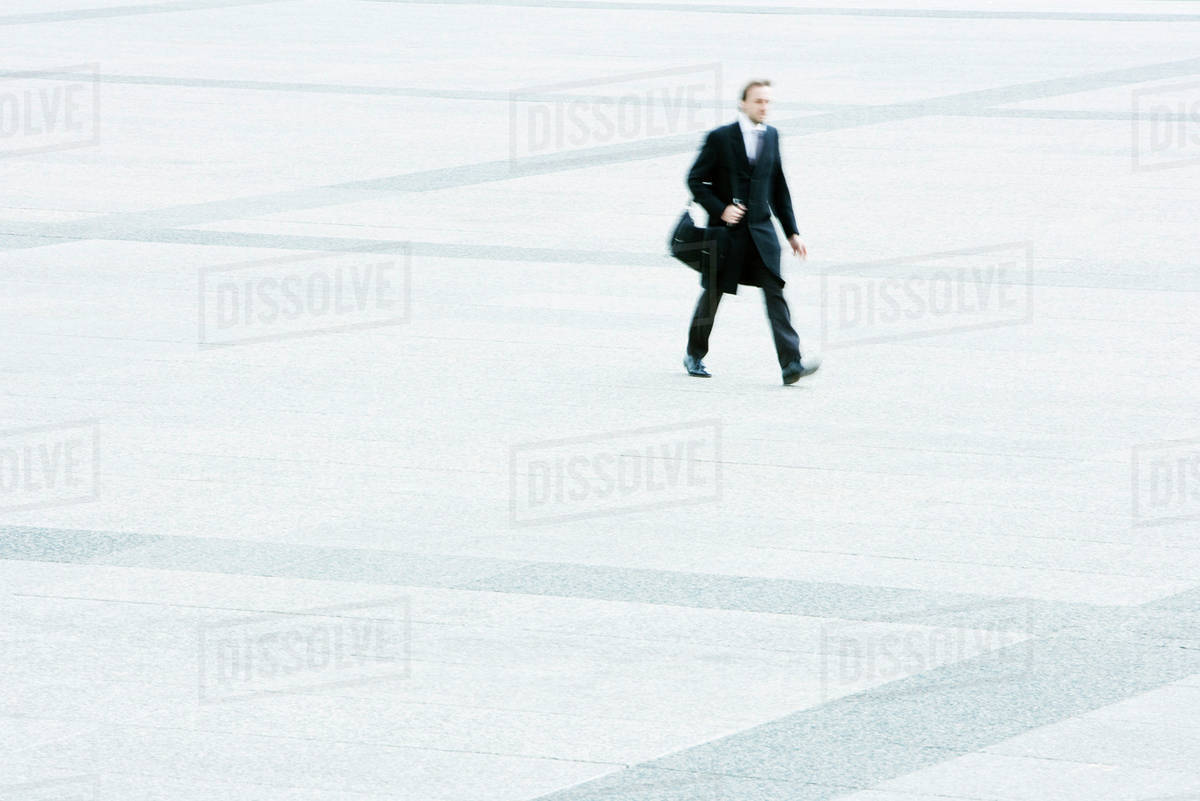 Businessman hurrying across public square - Royalty-free Stock Photo ...