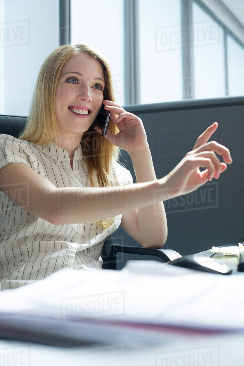 Office worker taking important phone call on smartphone - Stock Photo ...
