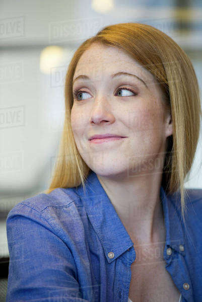 Young woman giving knowing look - Stock Photo - Dissolve