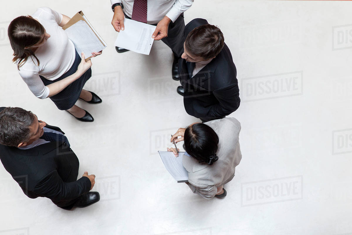 Executives standing in meeting, overhead view - Royalty-free Stock ...