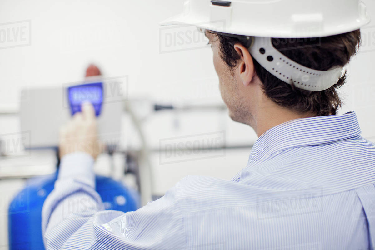 Technician operating industrial equipment - Royalty-free Stock Photo ...