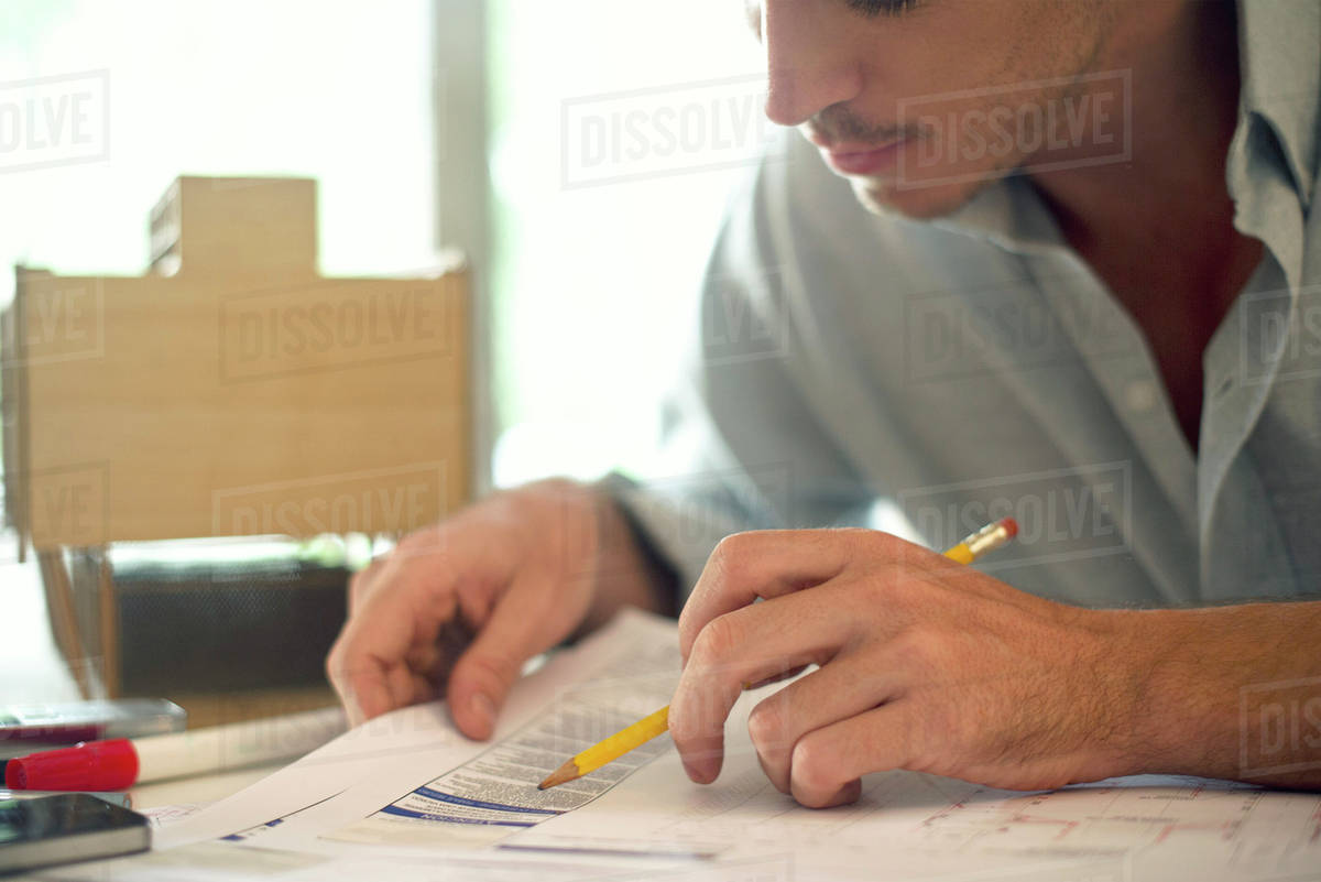 Businessman working on paperwork - Stock Photo - Dissolve