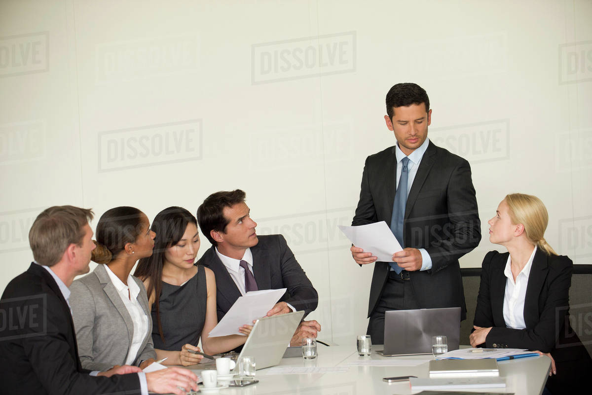 Executive giving presentation in meeting - Stock Photo - Dissolve
