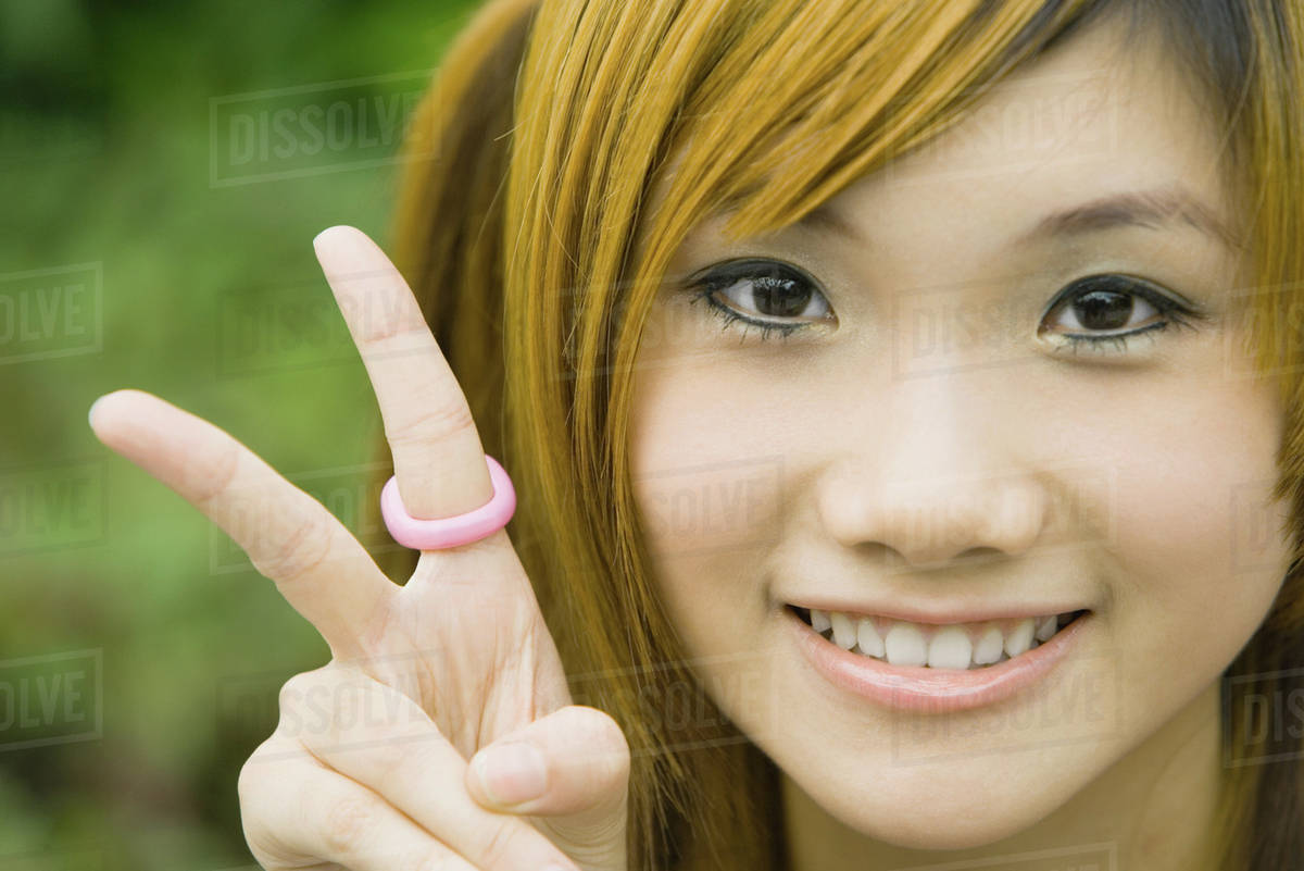 Teenage girl making peace sign, portrait - Royalty-free Stock Photo ...