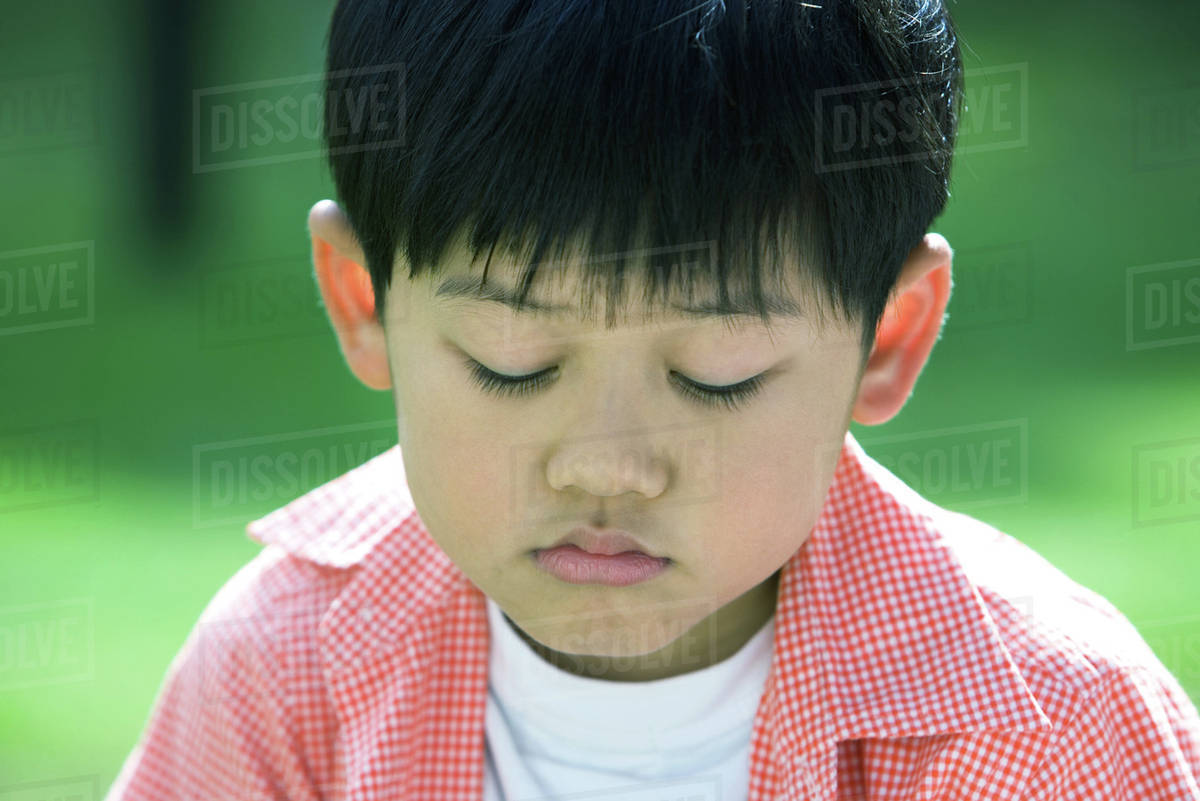 Boy with eyes closed, portrait - Stock Photo - Dissolve