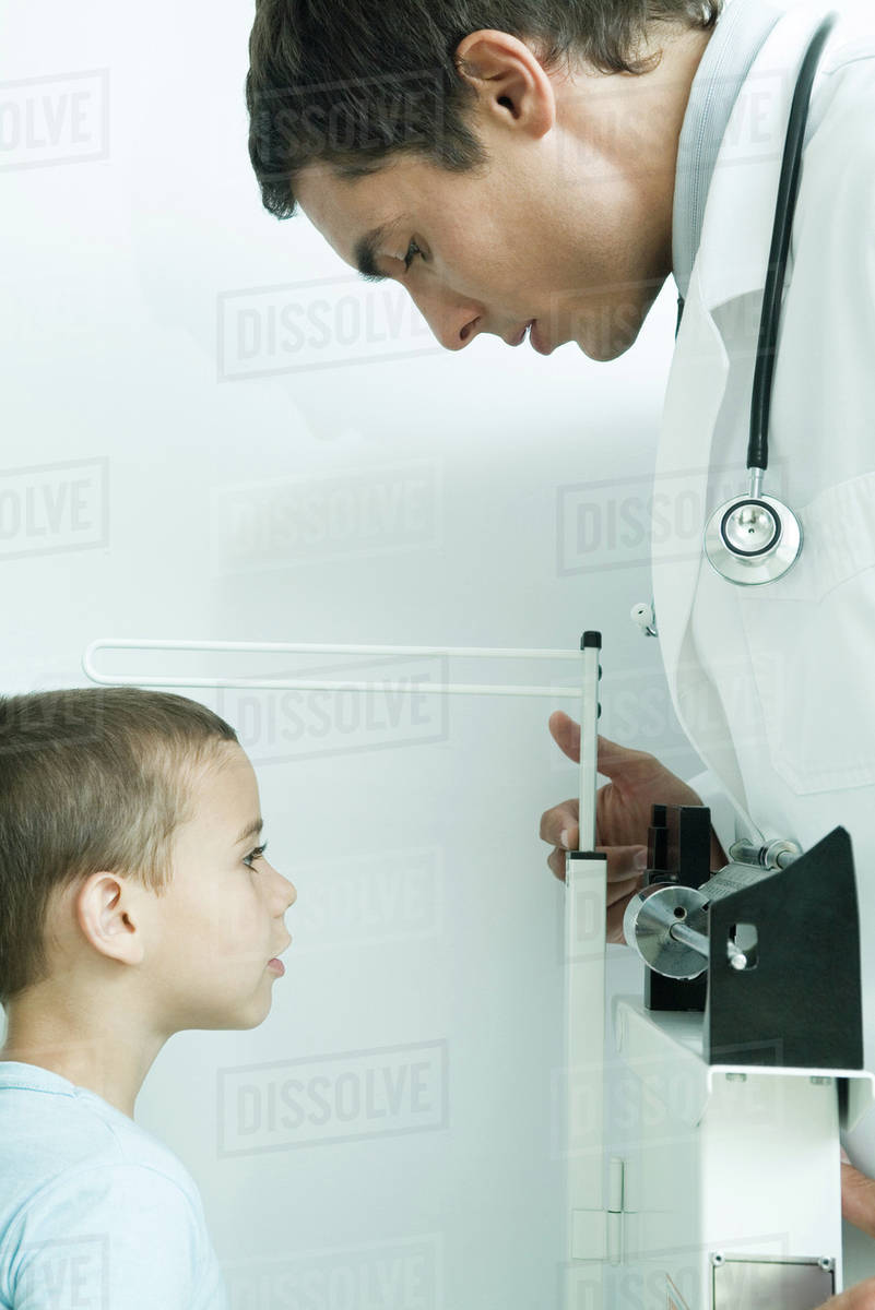 Doctor measuring boy's height - Royalty-free Stock Photo | Dissolve