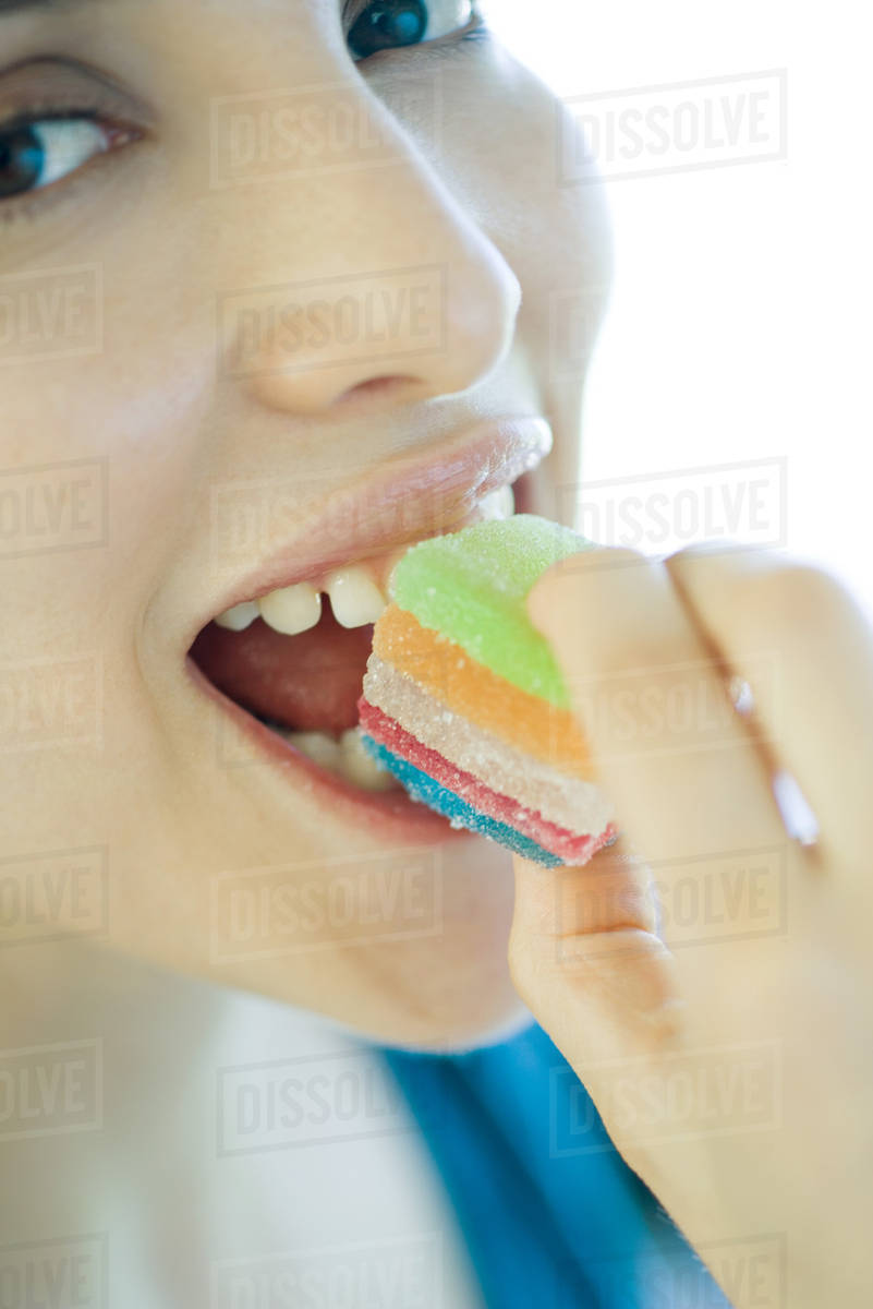 Woman eating candy, close-up of face - Royalty-free Stock Photo | Dissolve