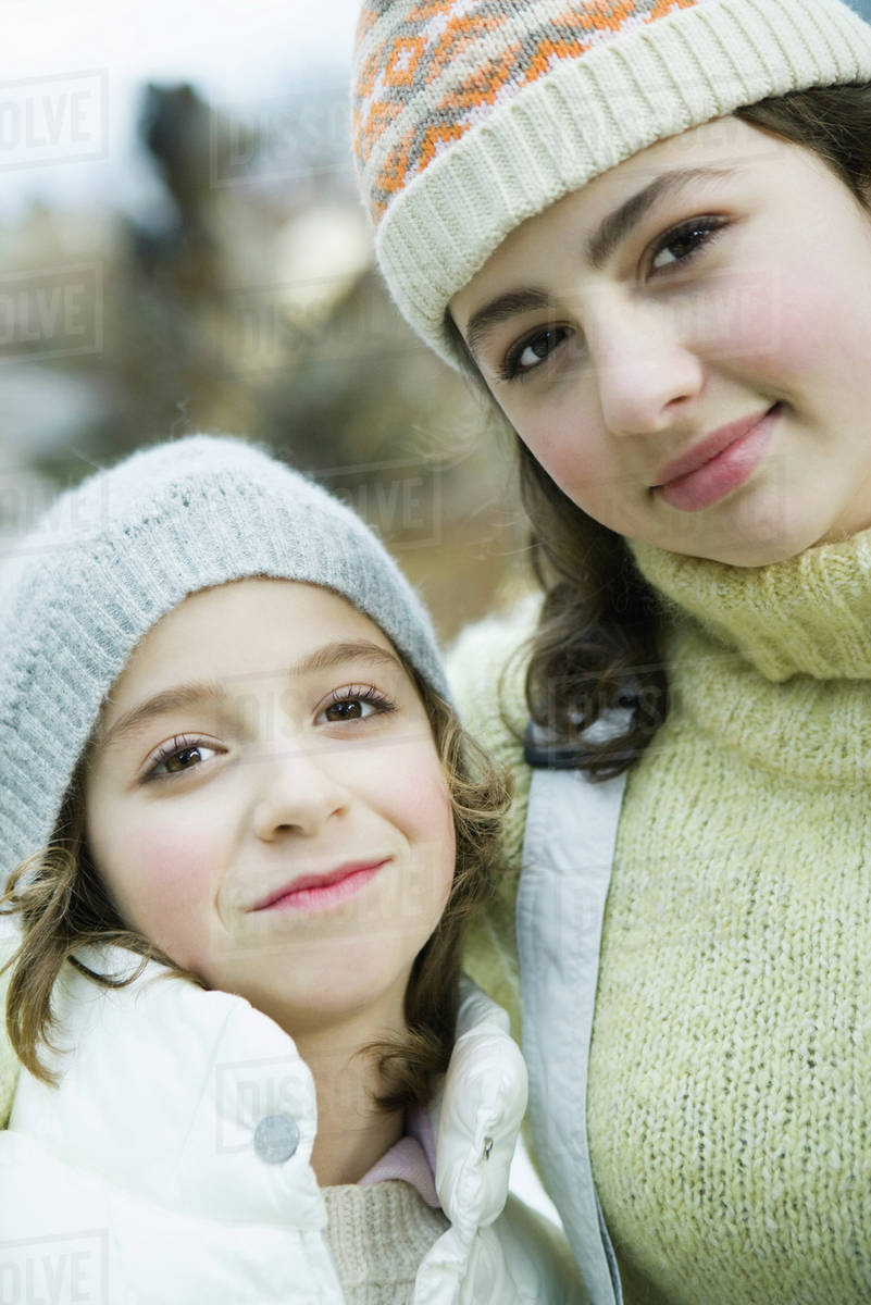 Two sisters smiling at camera, wearing knit hats, portrait - Stock ...