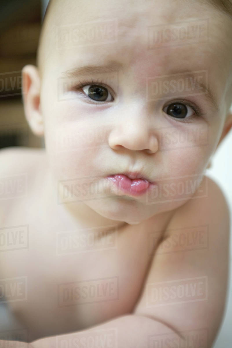 Baby frowning at camera, portrait - Royalty-free Stock Photo | Dissolve