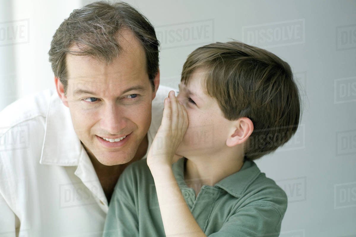 Boy whispering in father's ear, close-up - Royalty-free Stock Photo ...