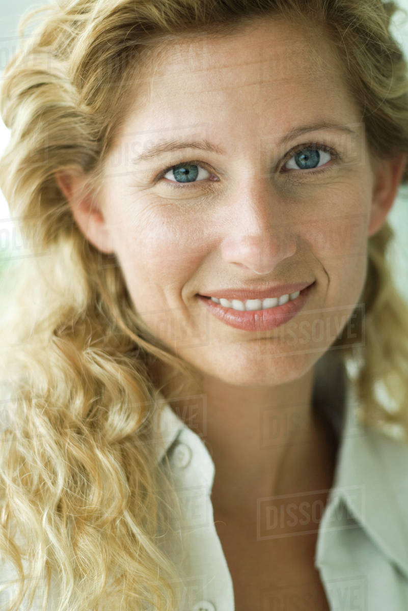Woman smiling at camera, portrait, close-up - Stock Photo - Dissolve