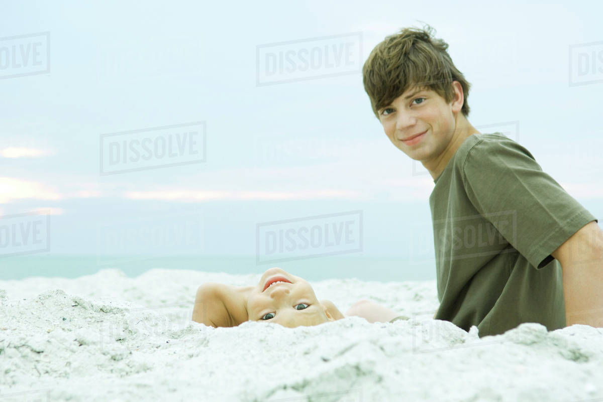 Two brothers at the beach, both smiling at camera - Royalty-free Stock ...