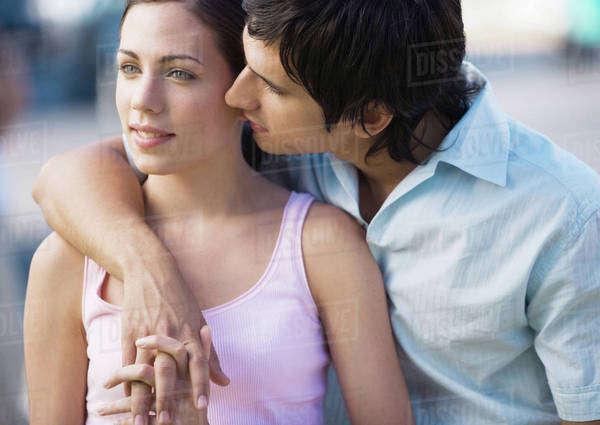 Young couple, man leaning over woman's shoulder - Royalty-free Stock ...