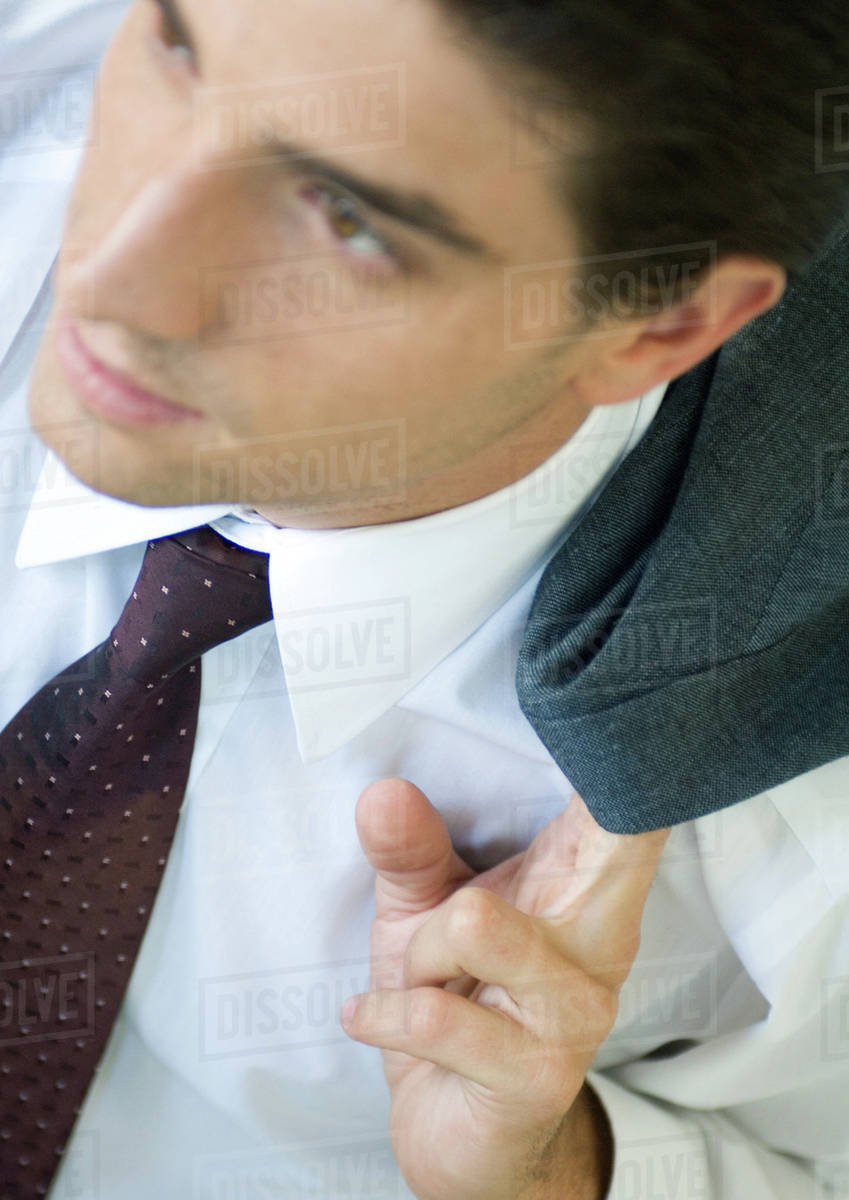 Businessman holding coat over shoulder - Royalty-free Stock Photo ...