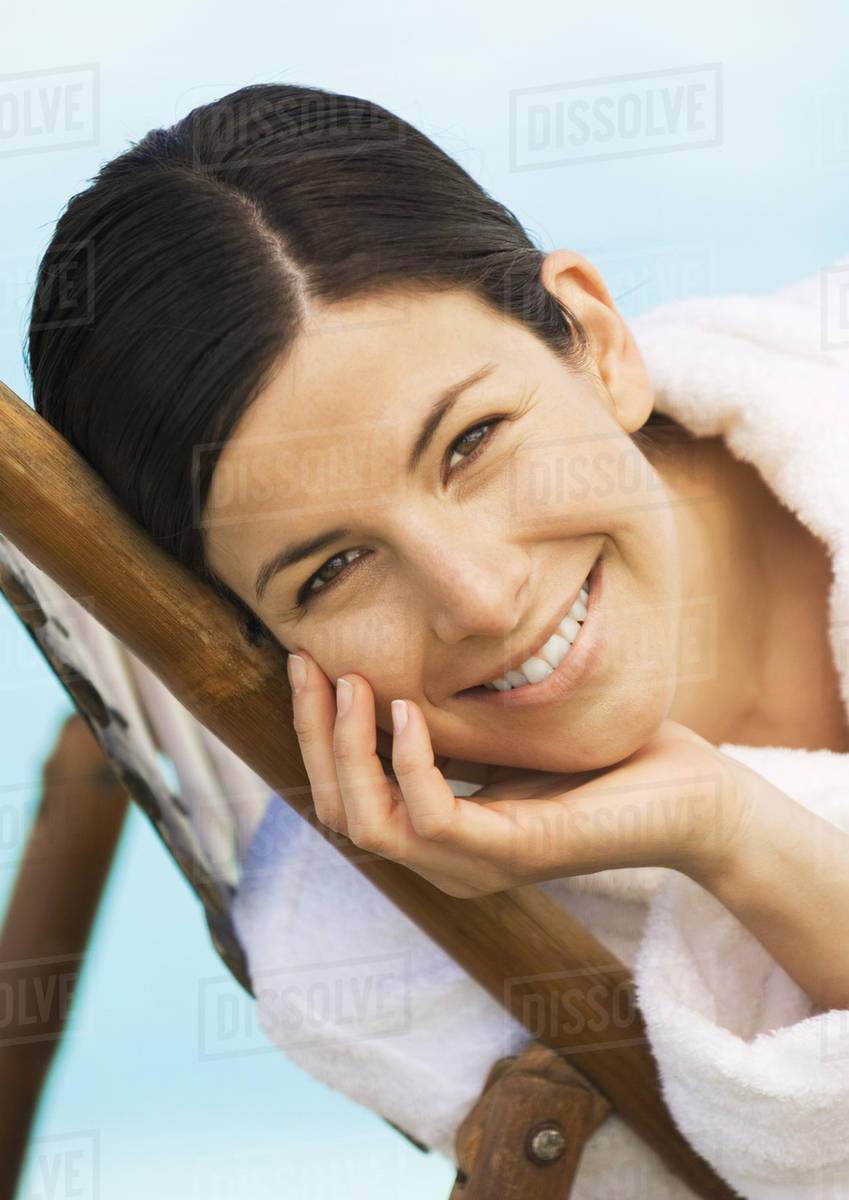 Woman reclining in chair, smiling - Royalty-free Stock Photo | Dissolve