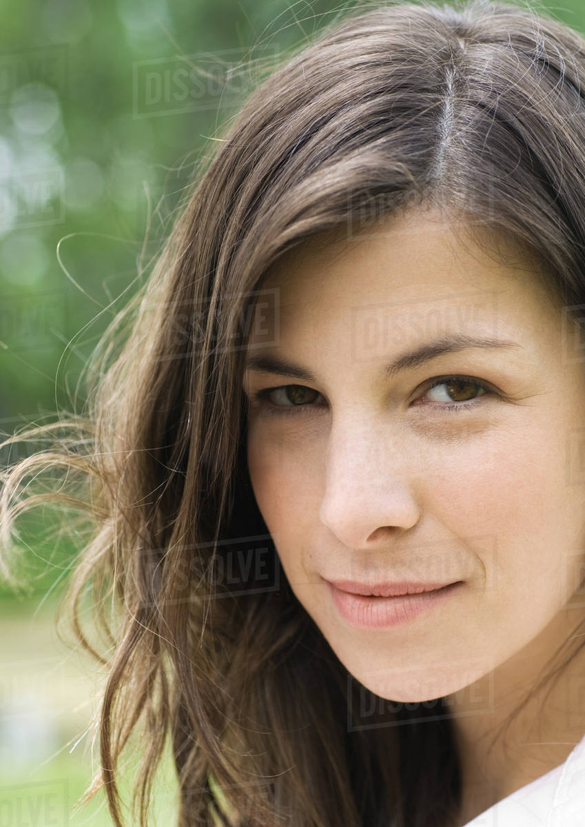 Woman looking sideways at camera, portrait - Stock Photo - Dissolve