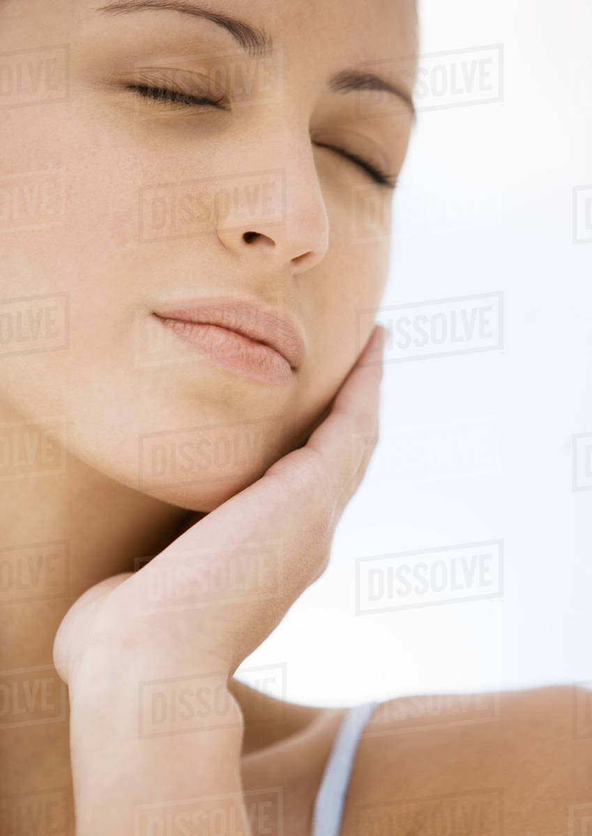 Woman resting face on hand with eyes closed - Royalty-free Stock Photo ...