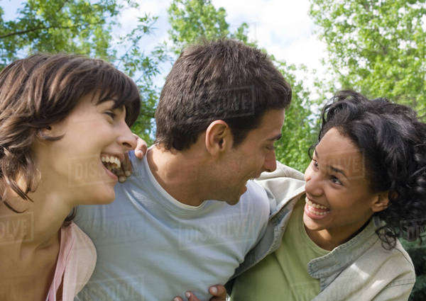 Three friends laughing - Stock Photo - Dissolve