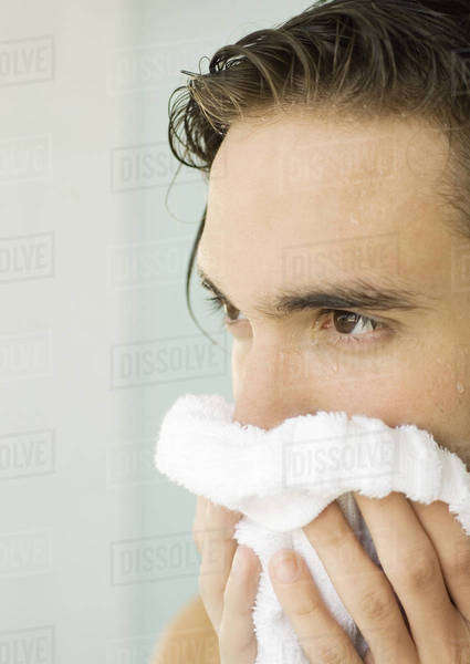Man drying face with towel - Royalty-free Stock Photo | Dissolve