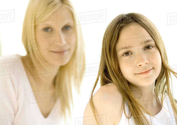 Girl, mother in background - Royalty-free Stock Photo | Dissolve